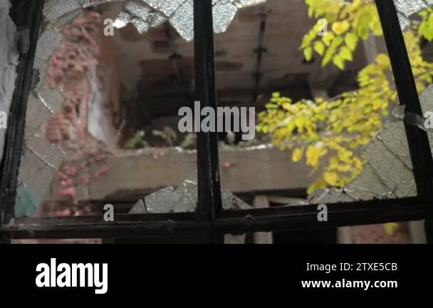 CLOSE UP, DOF: Looking through a ghoulish window with a broken glass at ...