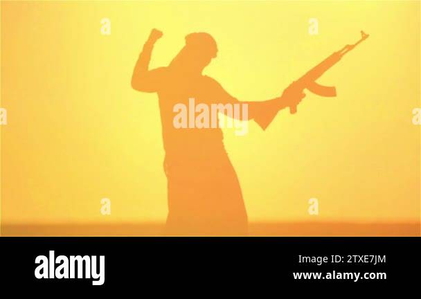 Islamic warrior with Kalashnikov at sunset day. Muslim fighter is ...
