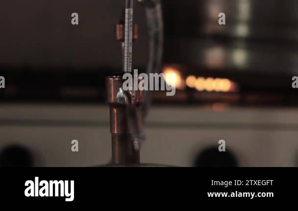 Home production of alcohol on flame fire. Alcohol distillation ...