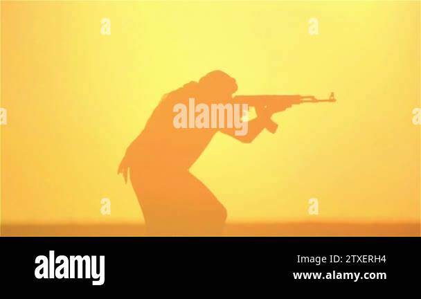 Islamic warrior with Kalashnikov at sunset day. Muslim fighter is ...