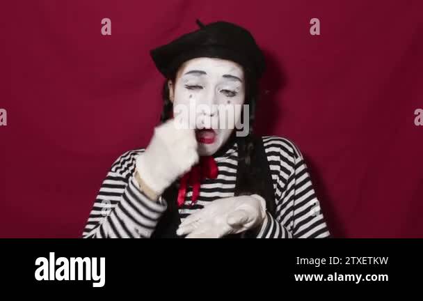 Beautiful mime girl depicts a strong upset and crying, looking at the ...