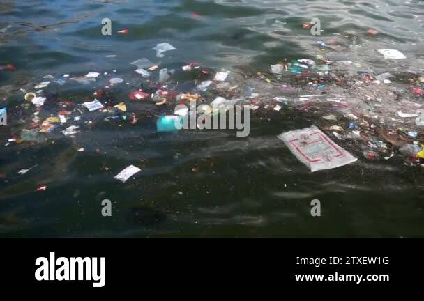 Trash and garbage floating on the surface of the water. Water pollution ...