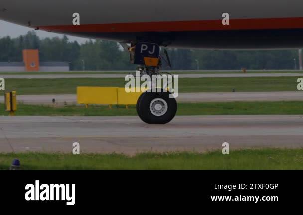Landing gear of taxiing aircraft. Fore wheel and part of fuselage of an ...