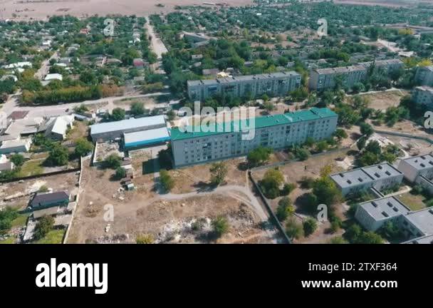 Aerial pan shot of Askania-Nova with multistory houses and parks in ...