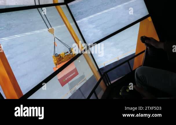 Ship crane simulator with a male hand controlling the load movement in ...