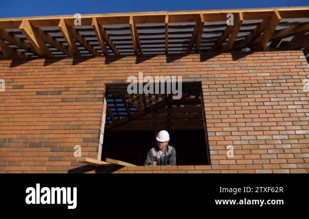 Man in window of building house Stock Video Footage - Alamy