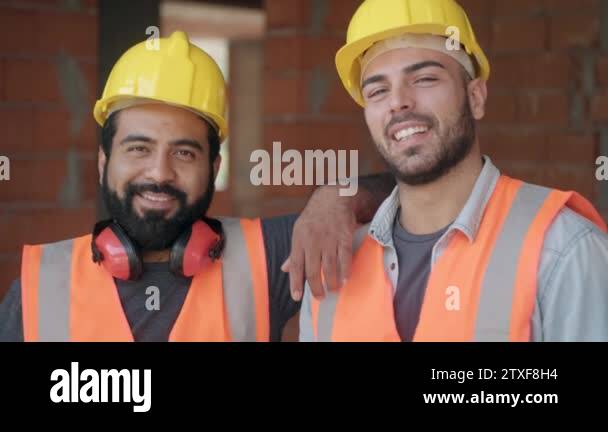 People working in construction site. Portrait of happy men at work in ...