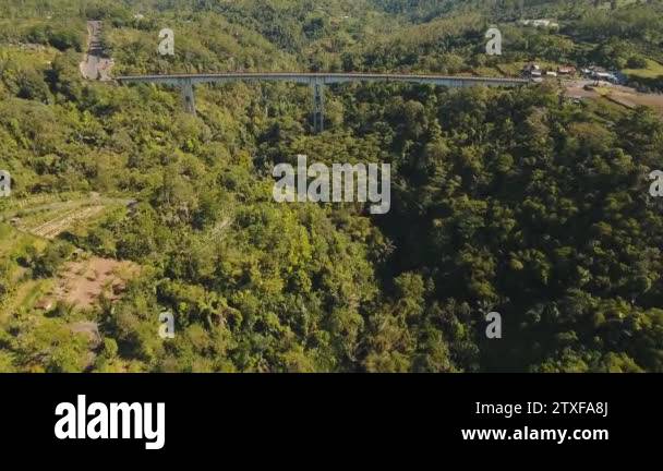 Bridge with car road over mountain canyon, mountains, rainforest ...