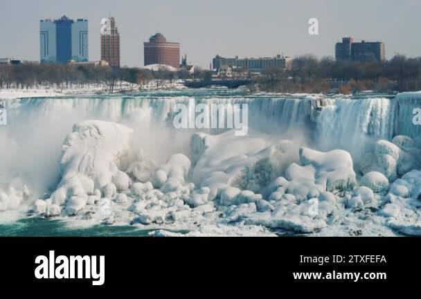 American side of Niagara Falls in winter. The buildings of hotels and ...