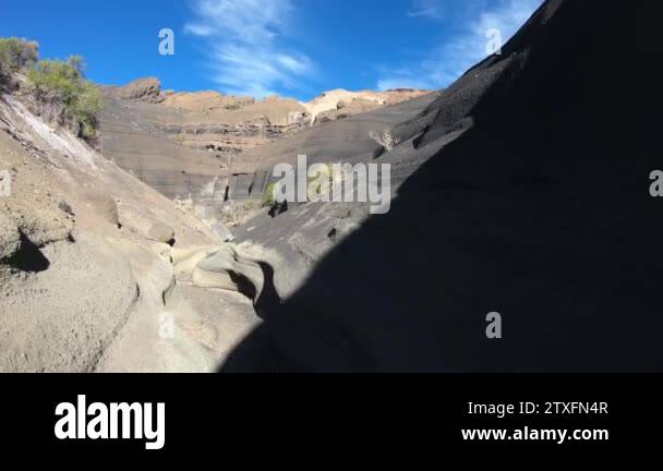 Walking inside volcano malacara grey debris, dry river of vocanic ...
