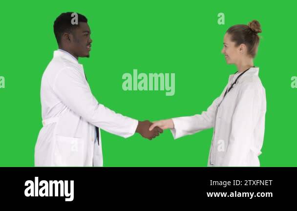 Doctors shaking hands and posing to camera on a Green Screen, Chroma ...