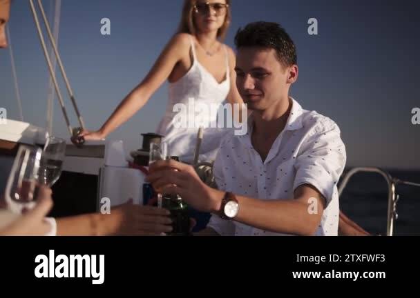 Young people is resting on the sailing yacht. Corporate party on a ...