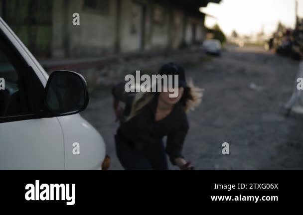 The scene of the scared girl runs away from the zombie, hiding behind ...