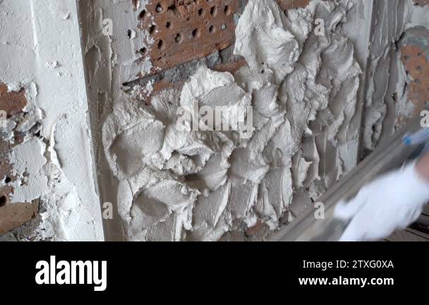 Plaster Builder aligns plaster layer on brick wall with rule,Repair and ...