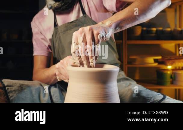 Artist operates hands, which gently creating correctly shaped handmade ...