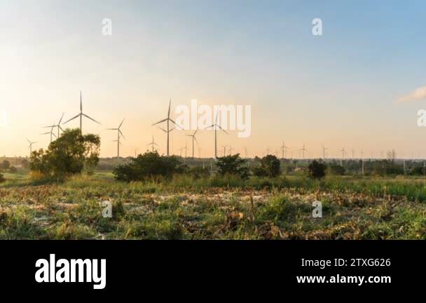 Timelapse of Wind turbine farm in beautiful nature in sunset time ...