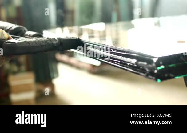 Production and manufacturing of pvc windows, the working specialist glues the glass of the ...