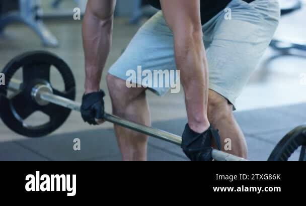 Guy bodybuilder in the gym, works with a barbell, bench press ...