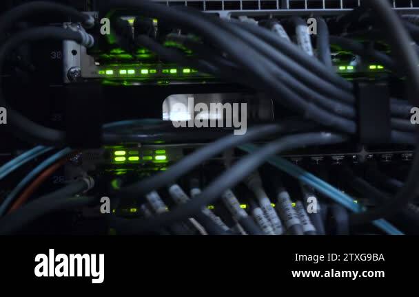 Ethernet Network Connection Hub. Blinking lights in a dark server room, Close-up view of ...
