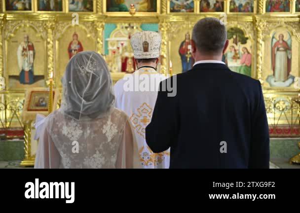 Couple and priest at church wedding ceremony Stock Video Footage - Alamy