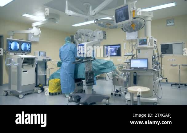 Surgical procedure is being performed in a fully-equipped medical room ...