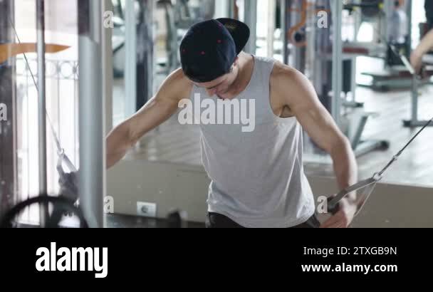 A shirtless guy at the gym, trains his body to stay fit and have ...