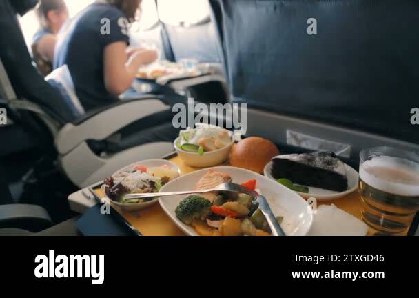 Passenger eats food on Board the plane Stock Video Footage - Alamy