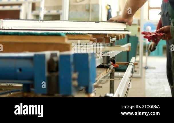 Production and manufacturing of pvc windows, male worker produces pvc ...