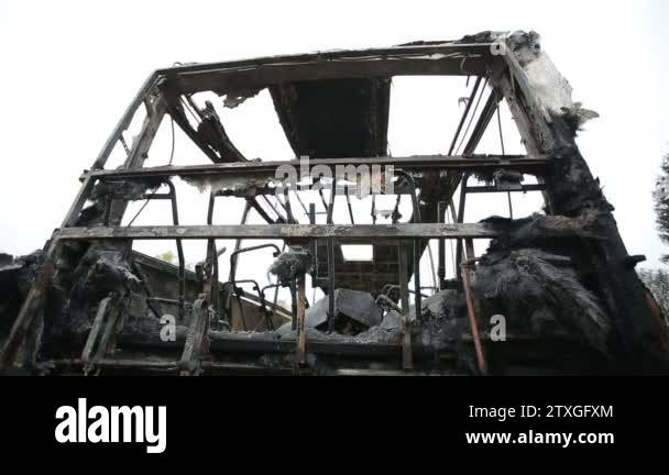 Burned-out passenger bus on the side of the road Stock Video Footage ...