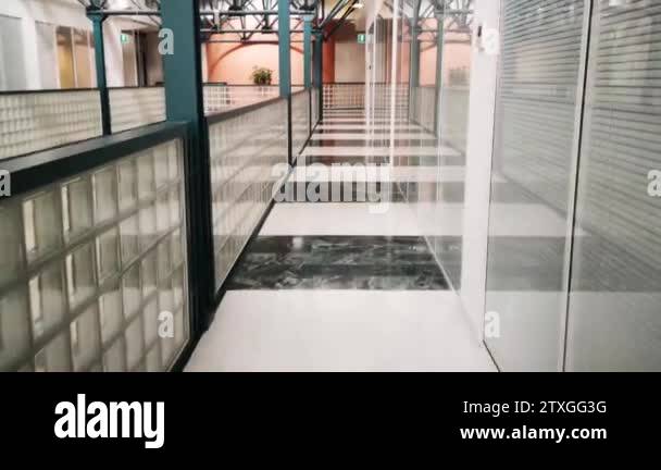 shaky walking in modern office corridor lobby first person point of ...