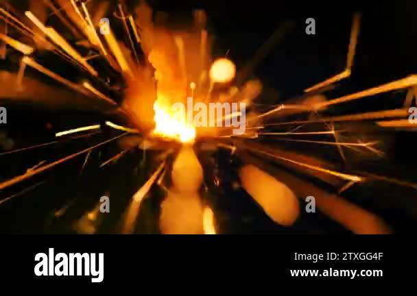 Sparkler Over Orange. Gun powder sparks shot against deep dark ...