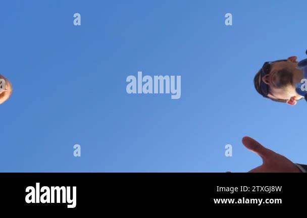 Low angle view of two successful businessmen meeting and shaking hands ...