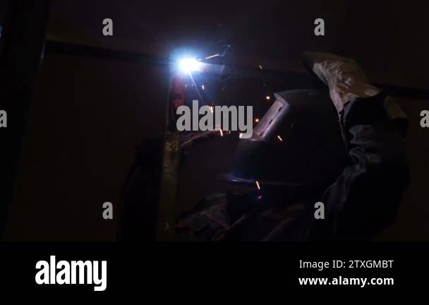 Welder Worker Performs Jump Welding. Worker Welder Performs Arc-Welding ...