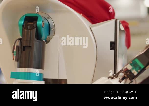 Humanoid robot with display on front side turning and unflexing arm ...