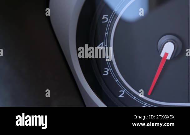 The arrow of a tachometer is moving, increasing to a middle value of ...