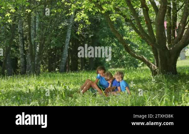 Kids reading under tree Stock Videos & Footage - HD and 4K Video Clips ...