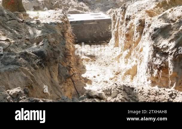 large big ditch for water, gas, oil pipes. deep trench with concrete ...