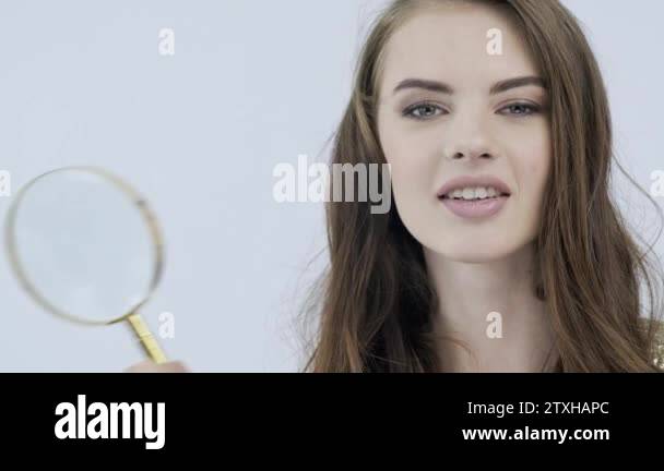 Woman makes kiss with her lips. Beautiful woman with a magnifying glass ...