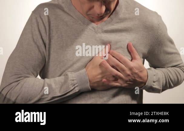 Man holding his chest with both hands, having heart attack or painful ...