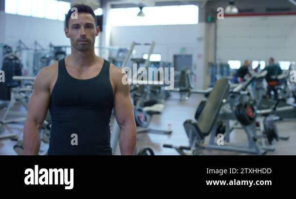 Guy bodybuilder in the gym, works with a barbell, bench press ...