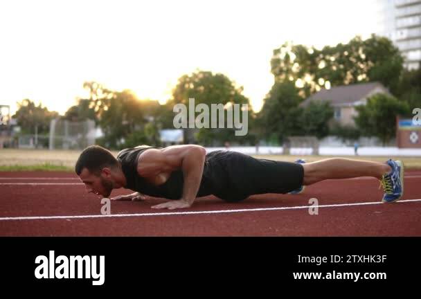 Gorgeous slow motion footage of a muscular man workout outdoors. Doing ...