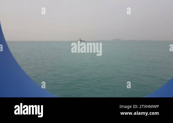 Ocean view in overcast weather from the ship's porthole. Ship in the ...