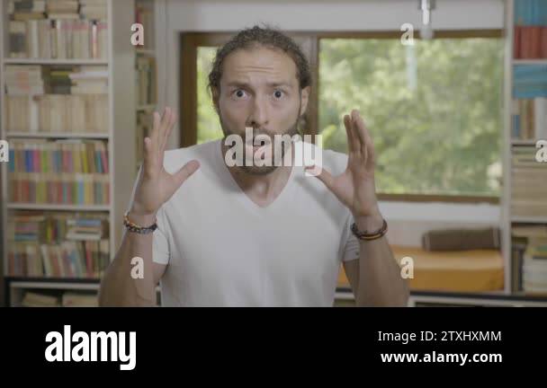 Reaction of good looking young man with dropping jaw and raised hands ...