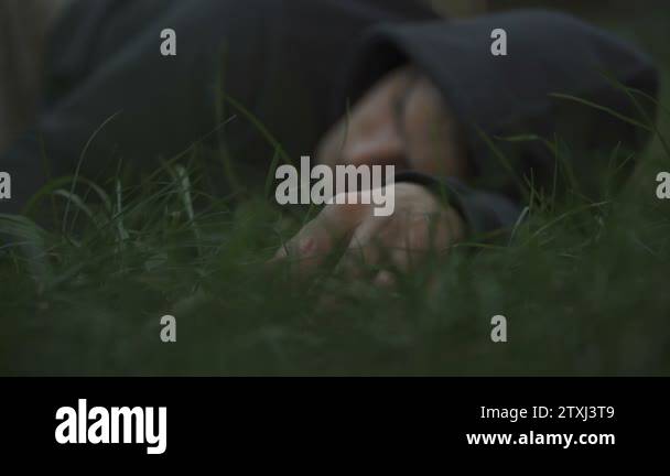 Victim of thugs lying on grass, mans corpse, murdered citizen, crime ...