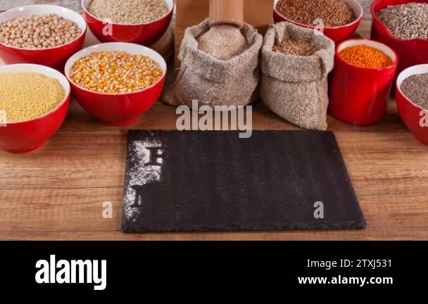 Clean eating concept - whole grains and mill around black hangdog with ...