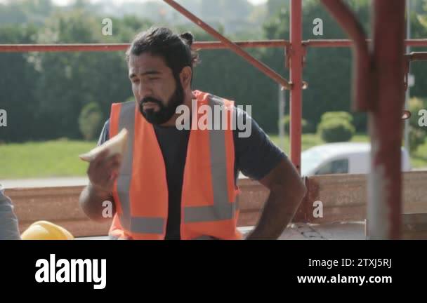 People working in construction site. Men at work in new house inside ...