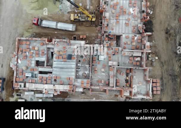 4k Birds eye view of building a house from scratch. Tower cranes ...