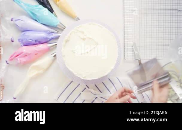 Time lapse. Step by step. Top view. Pastry chef stacking cake layers ...