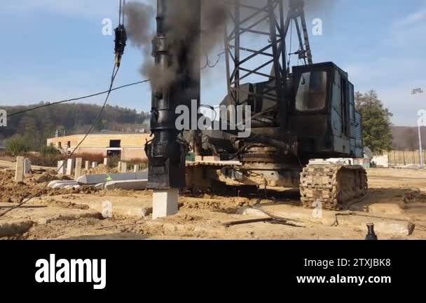 Machine drives into the ground piles construction. Construction of the ...