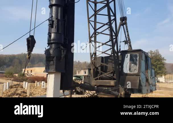 Machine drives into the ground piles construction. Construction of the ...